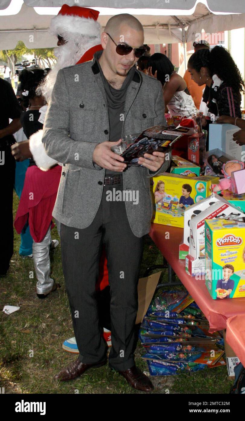 Rapper Pitbull attends his annual Christmas toy giveaway, signing ...