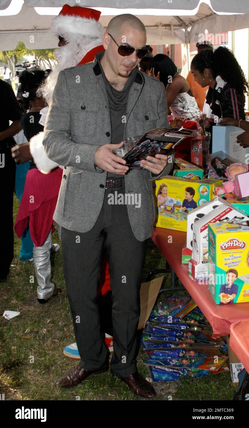 Rapper Pitbull attends his annual Christmas toy giveaway, signing ...