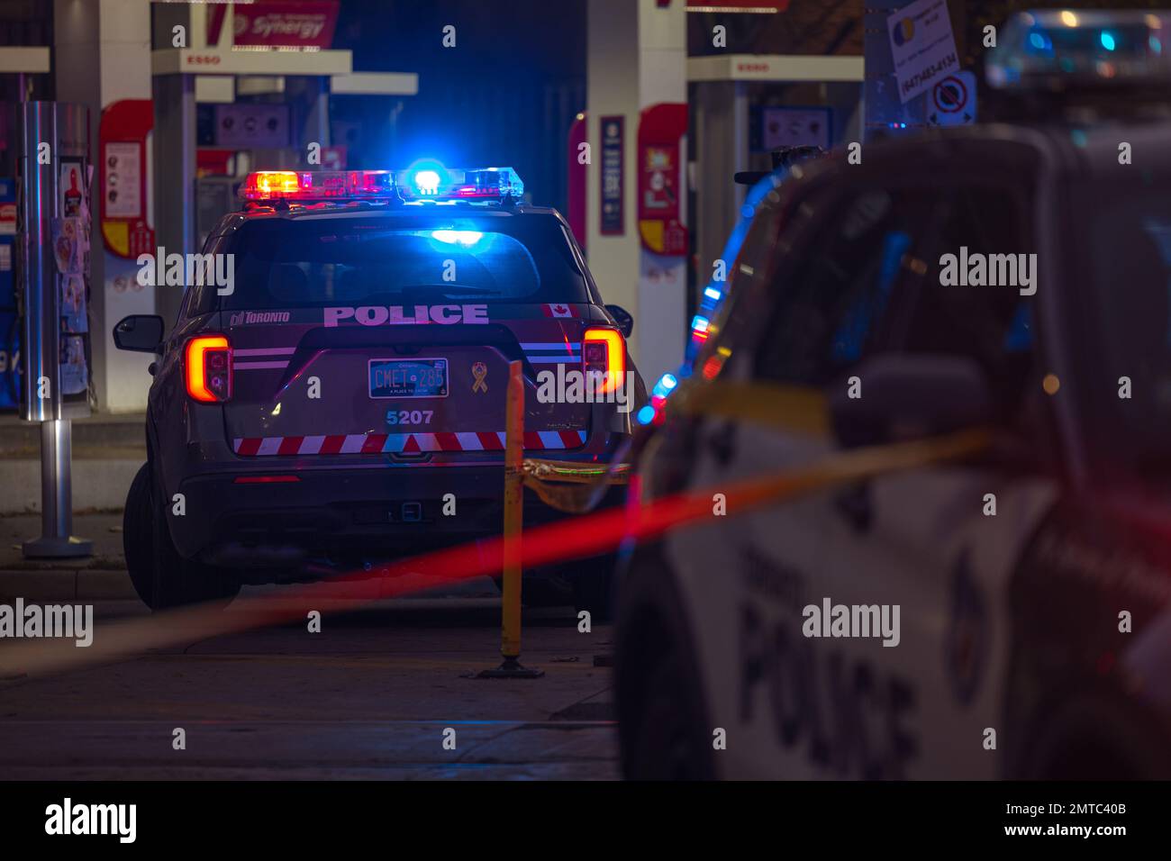 A Toronto Police Ford Explorer parked at a crime scene with emergency ...