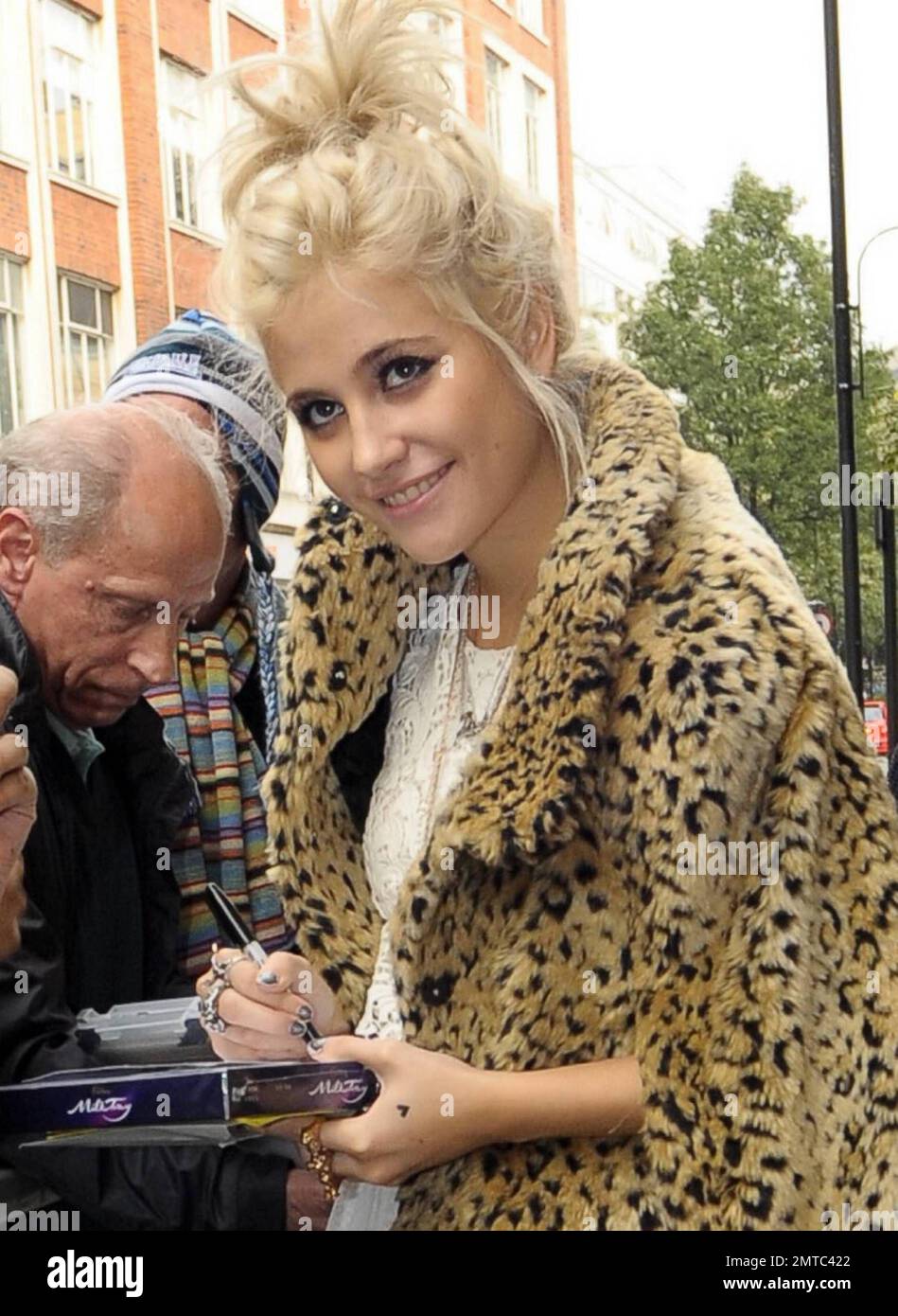UK pop singer Pixie Lott is met by a throng of fans who gathered ...