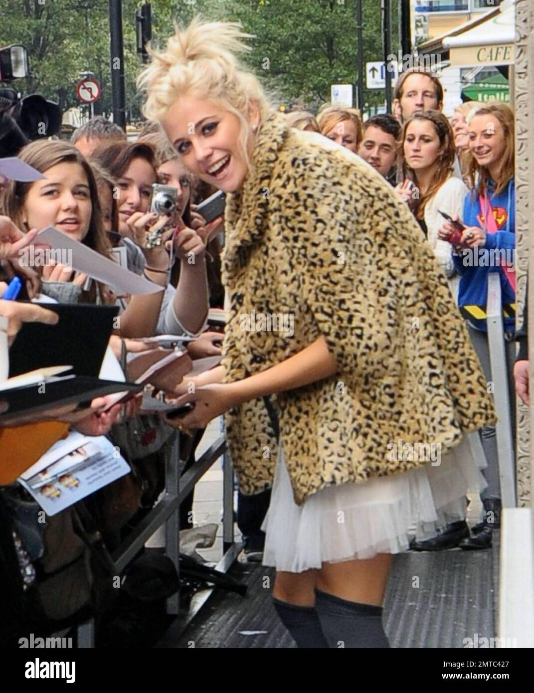 UK pop singer Pixie Lott is met by a throng of fans who gathered ...