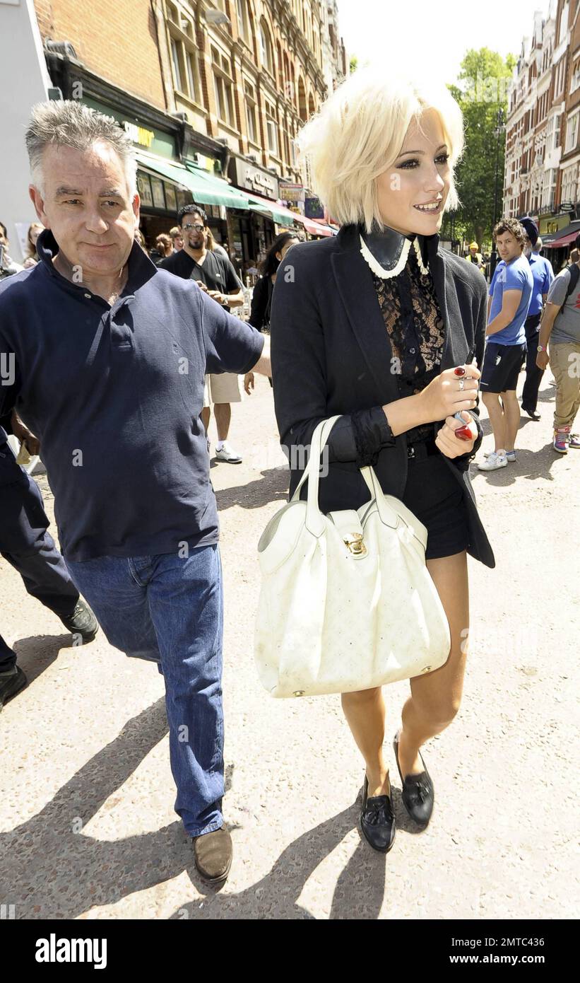 Wearing black short shorts, a black lace top and black jacket, Pixie ...