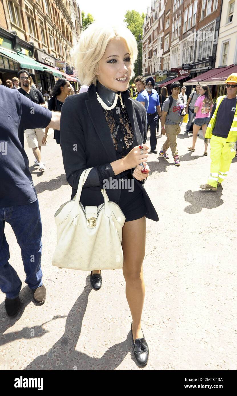 Wearing black short shorts, a black lace top and black jacket, Pixie ...