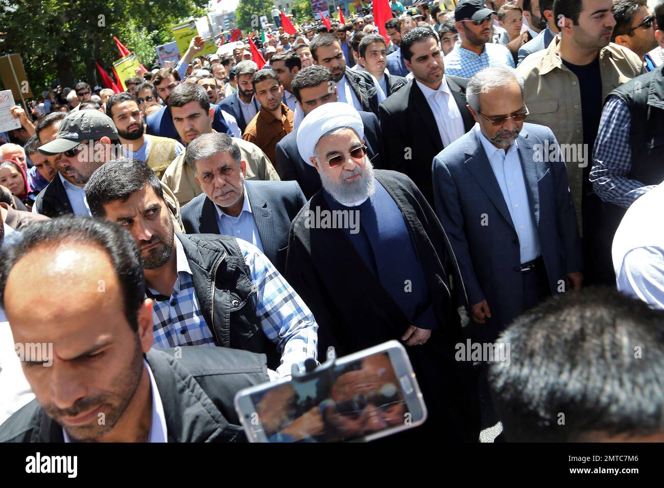 Iranian President Hassan Rouhani, center, attend an annual pro ...