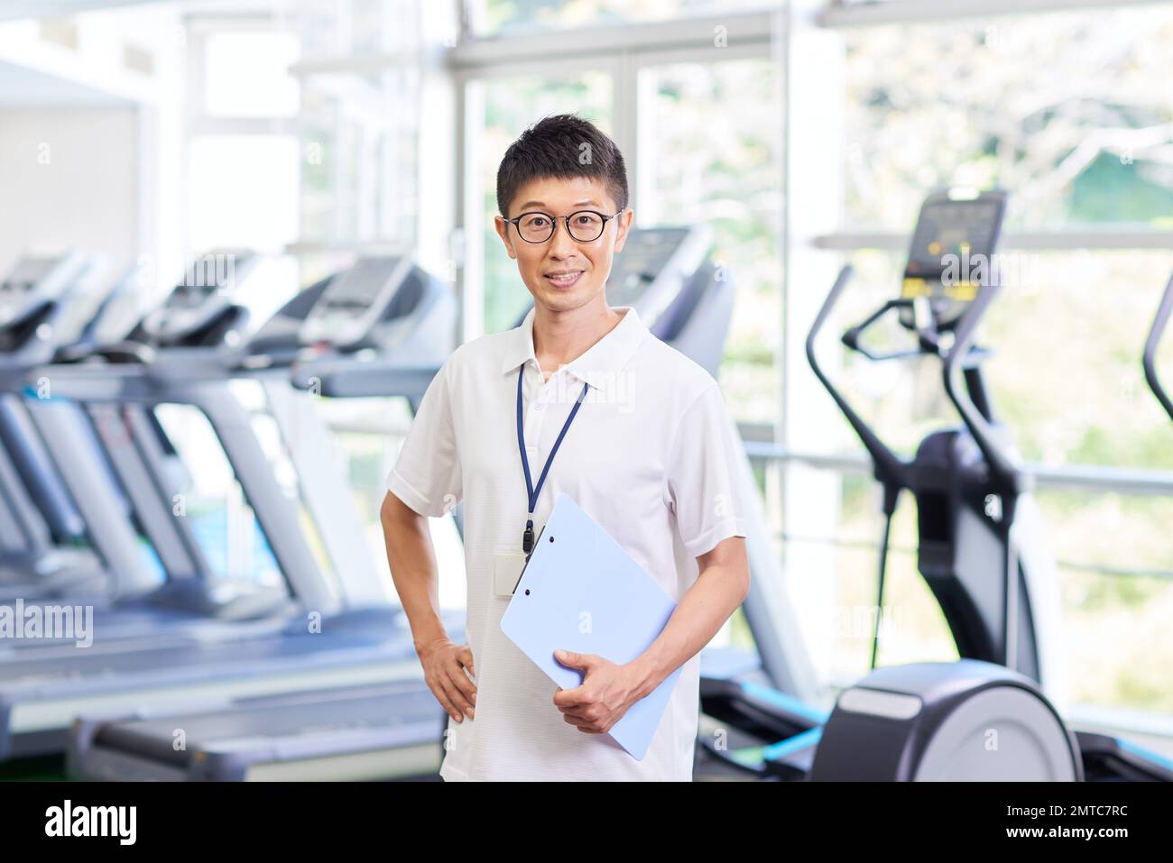 Japanese trainer at indoor gym Stock Photo - Alamy