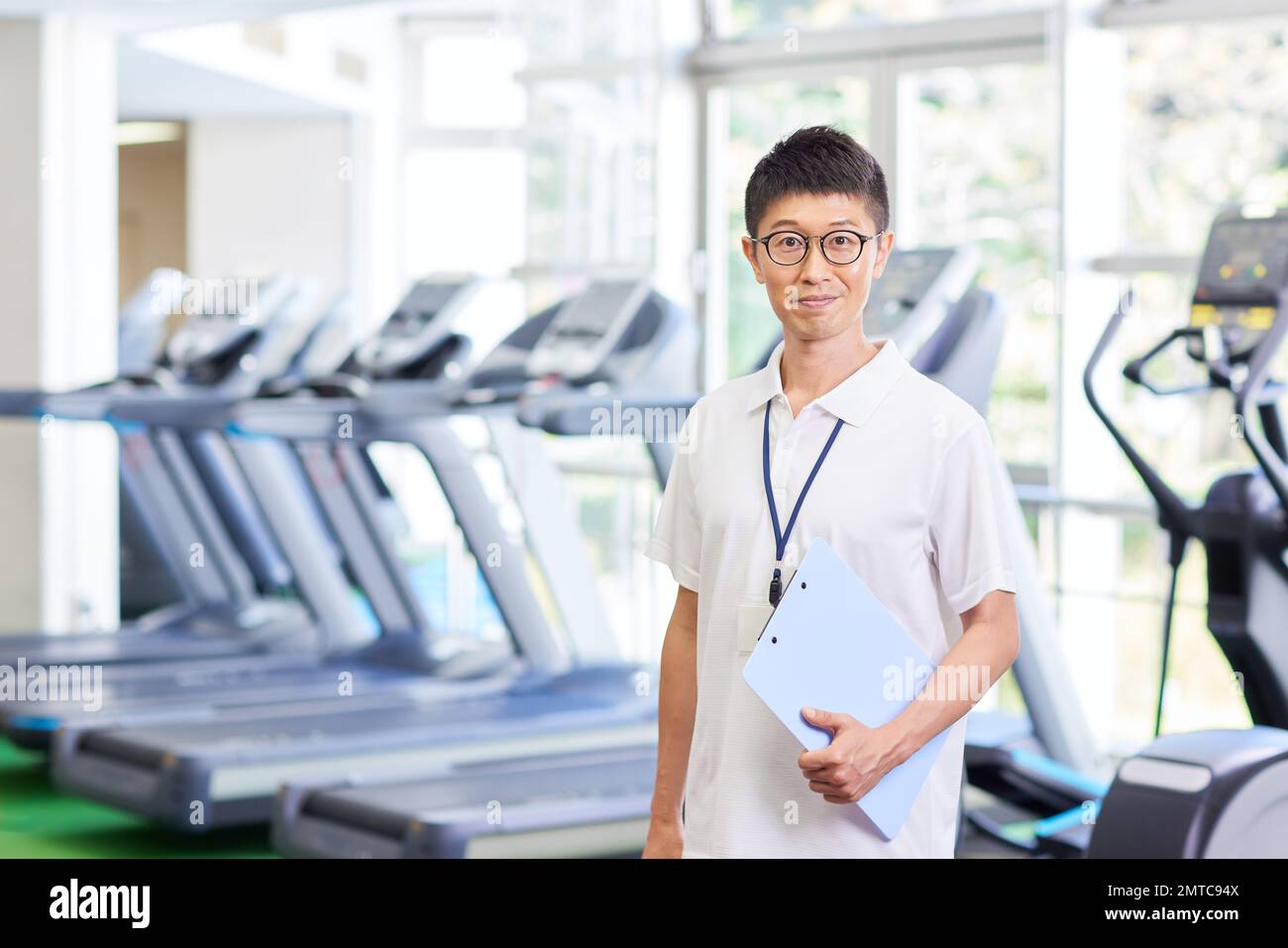 Japanese trainer at indoor gym Stock Photo - Alamy