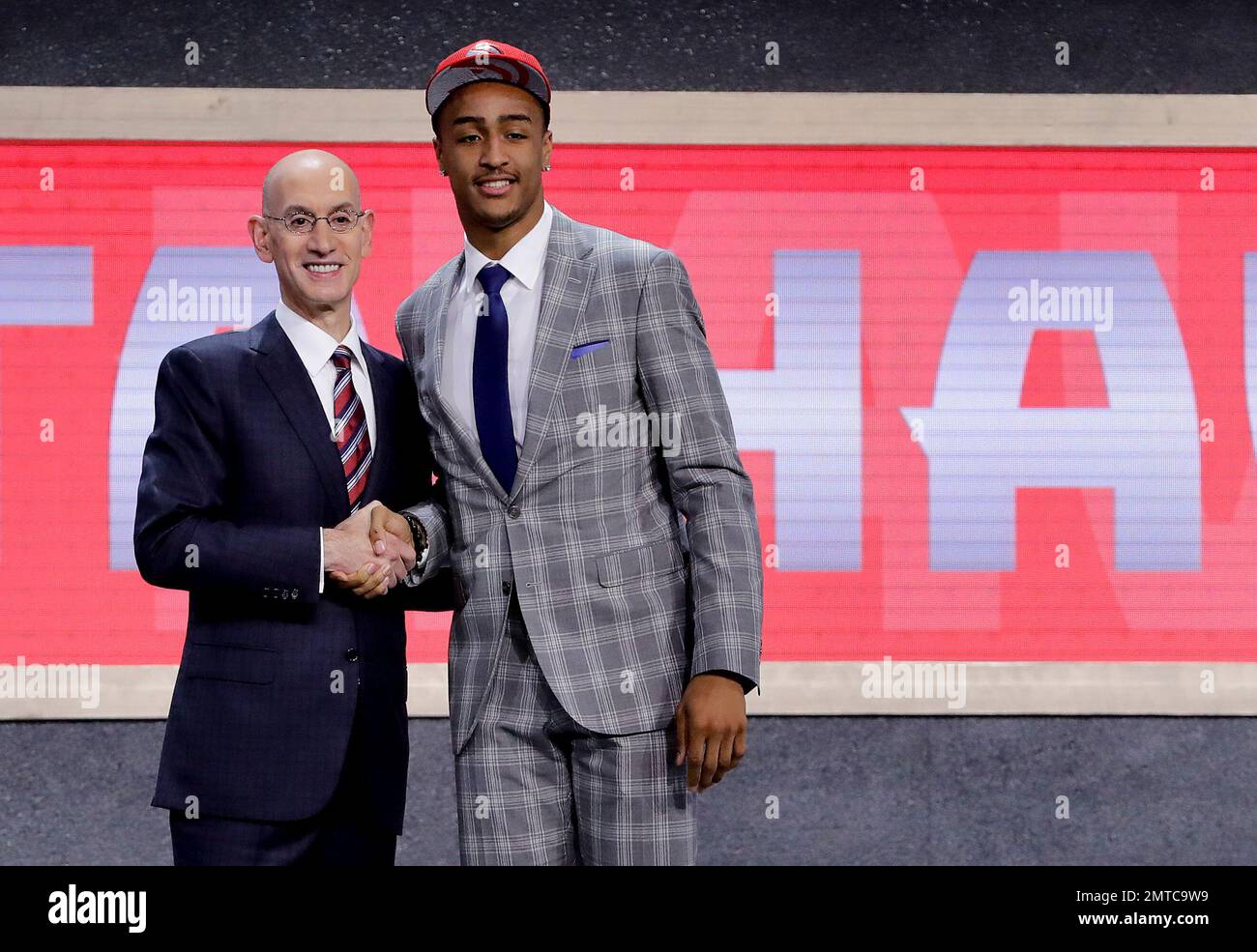 John Collins poses with NBA Commissioner Adam Silver after being ...