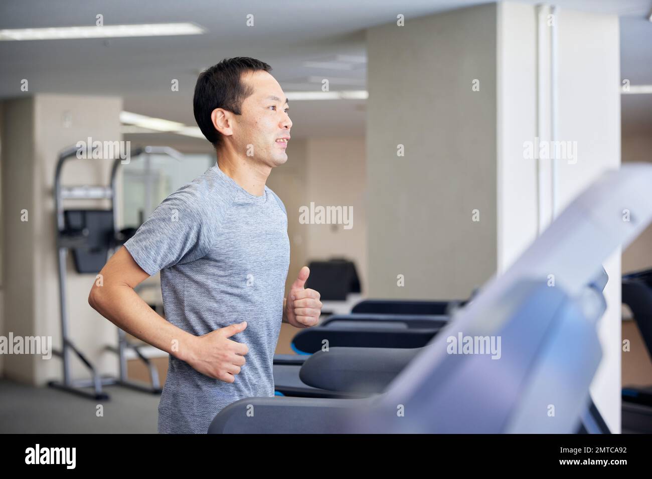 Japanese man training at indoor gym Stock Photo - Alamy