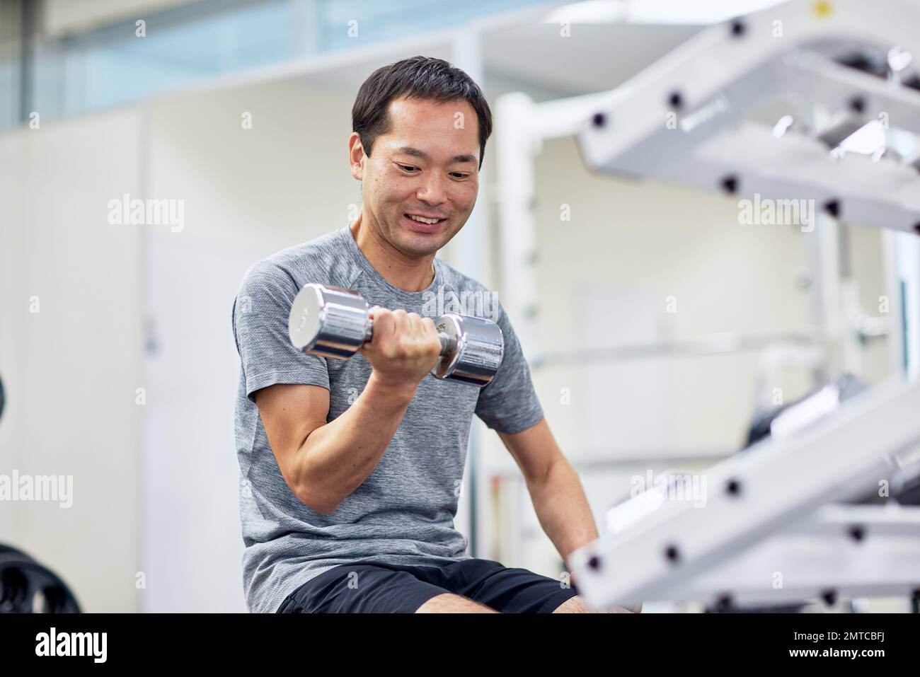 Japanese man training at indoor gym Stock Photo - Alamy