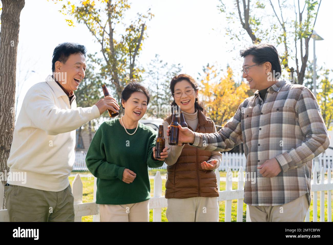 A group of old people standing in the rv campsite to drink beer Stock ...