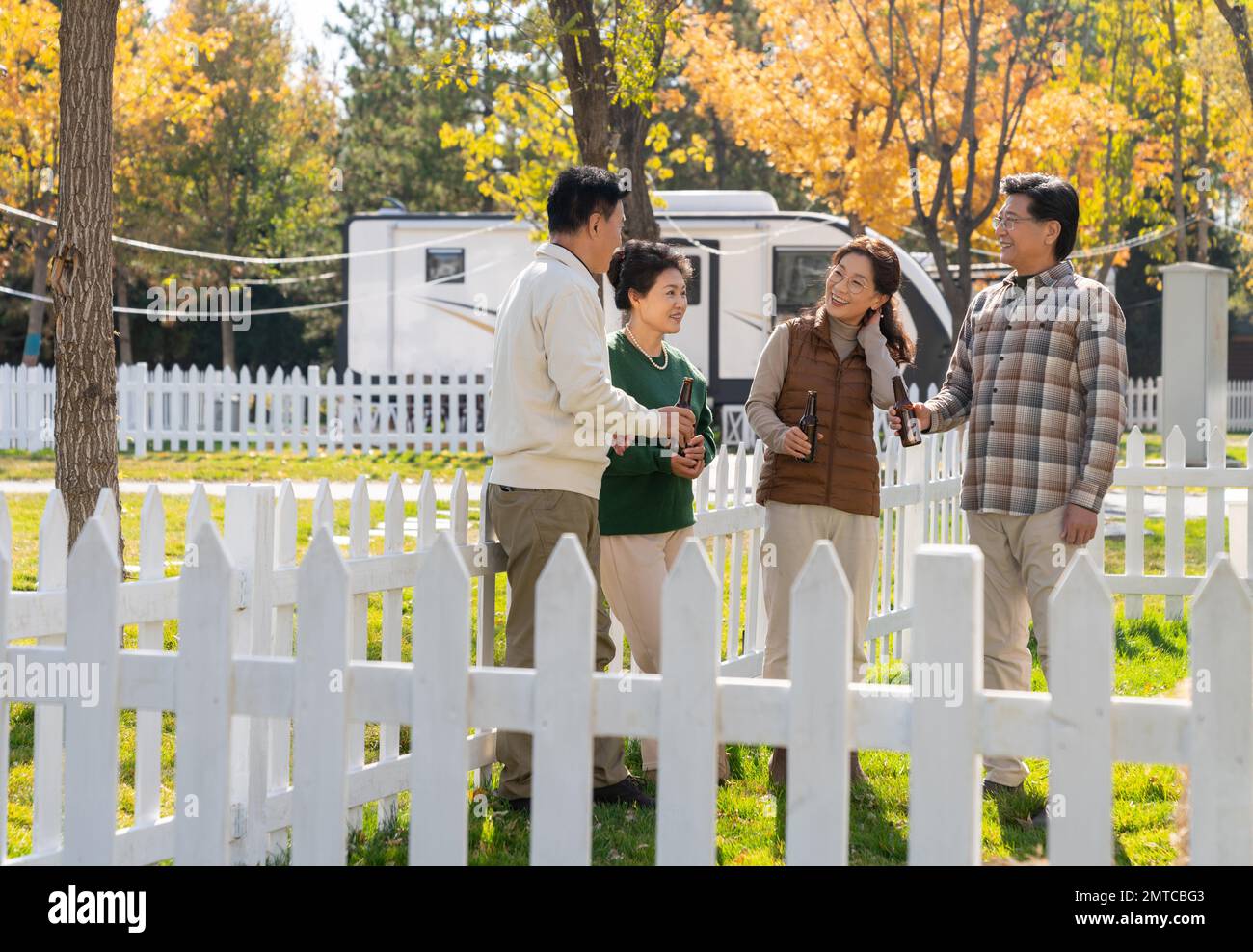 A group of old people standing in the rv campsite to drink beer Stock ...