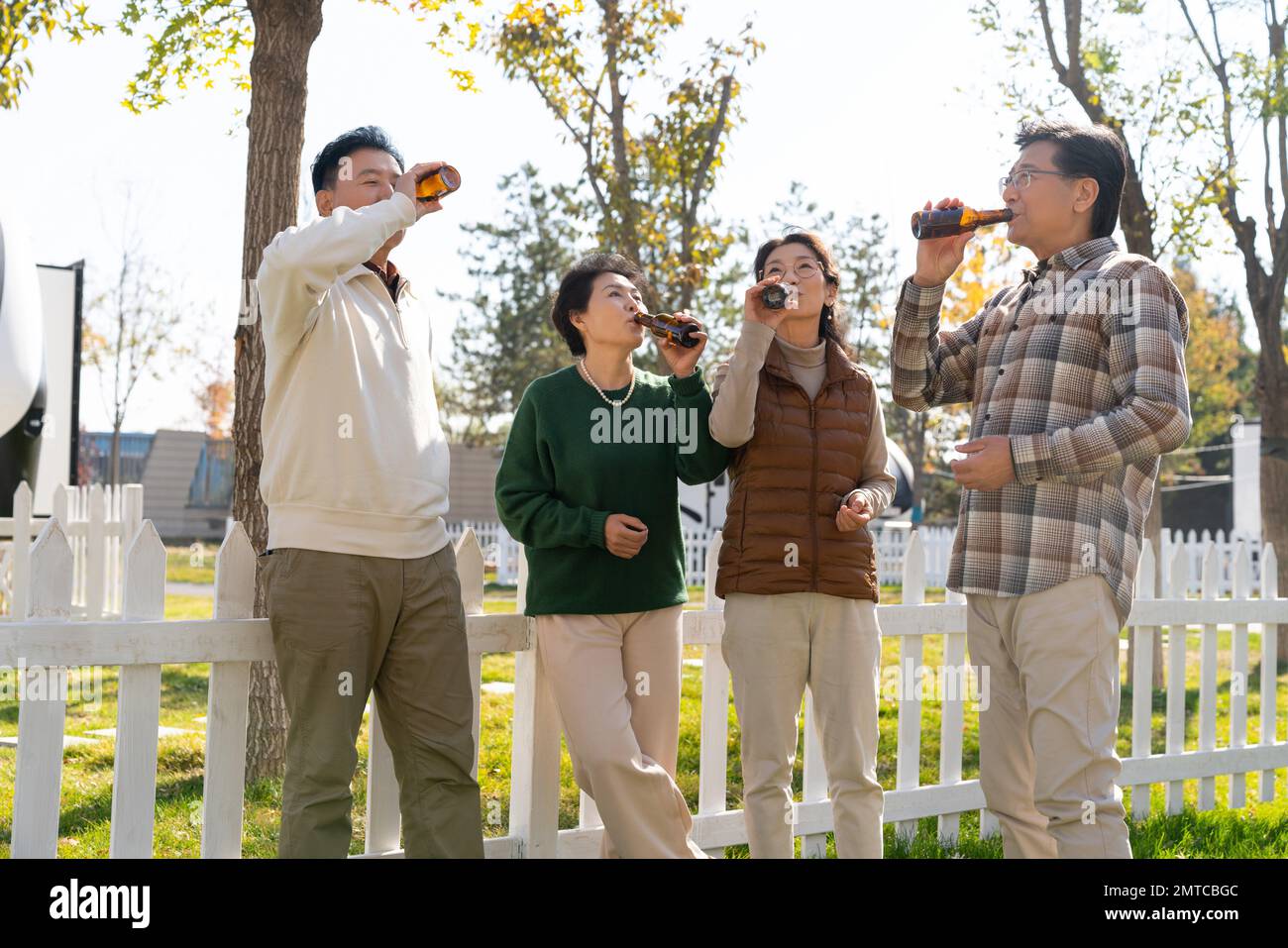 A group of old people standing in the rv campsite to drink beer Stock ...