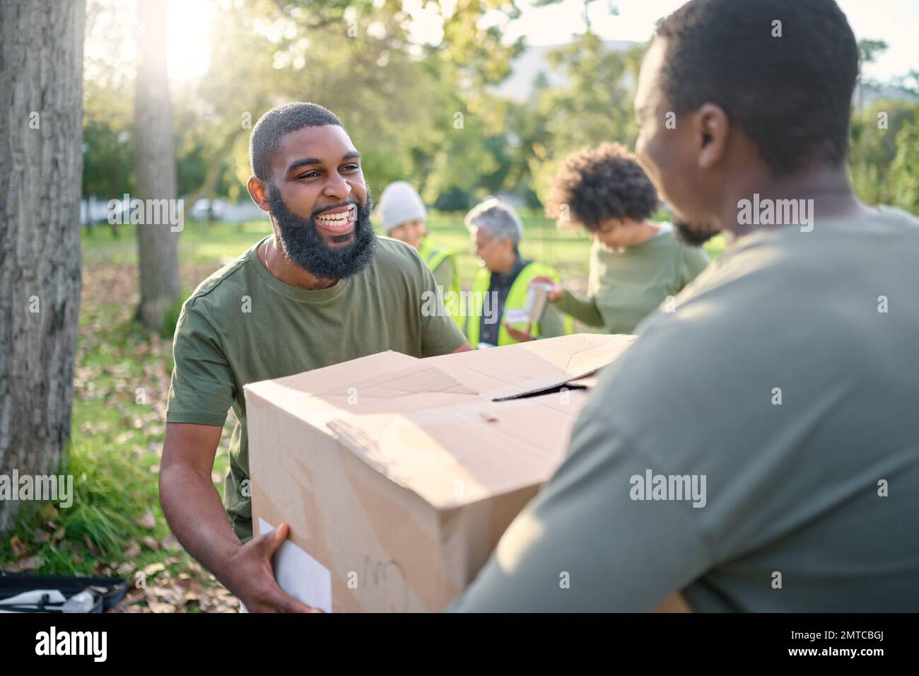 Community service, black man and giving box in park of donation ...