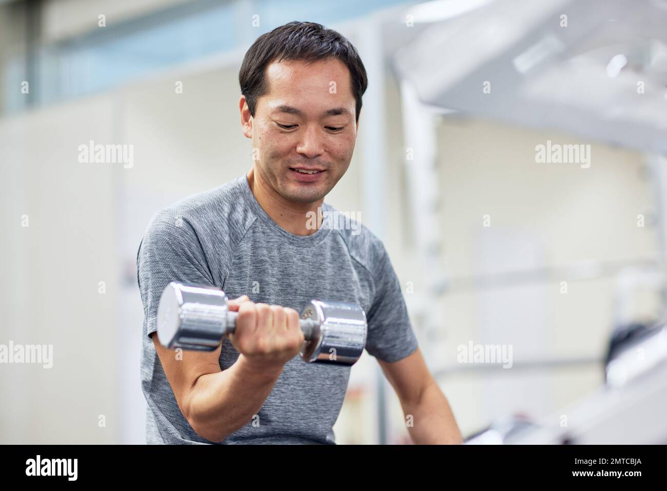 Japanese man training at indoor gym Stock Photo - Alamy