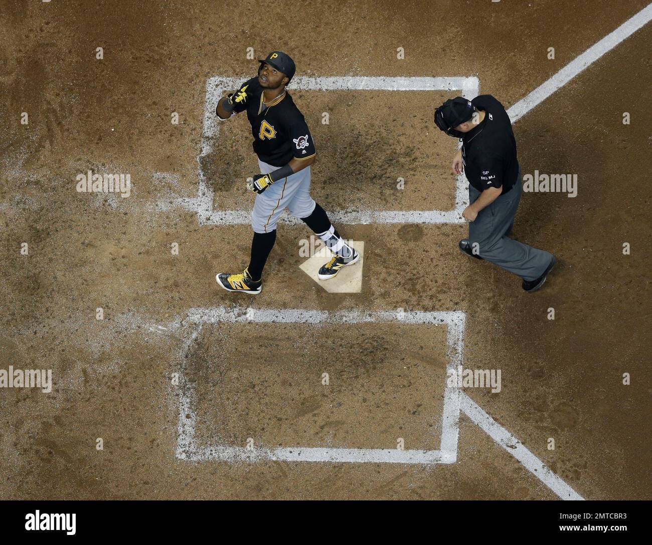 Pittsburgh Pirates' Gregory Polanco looks up as he crosses home after ...