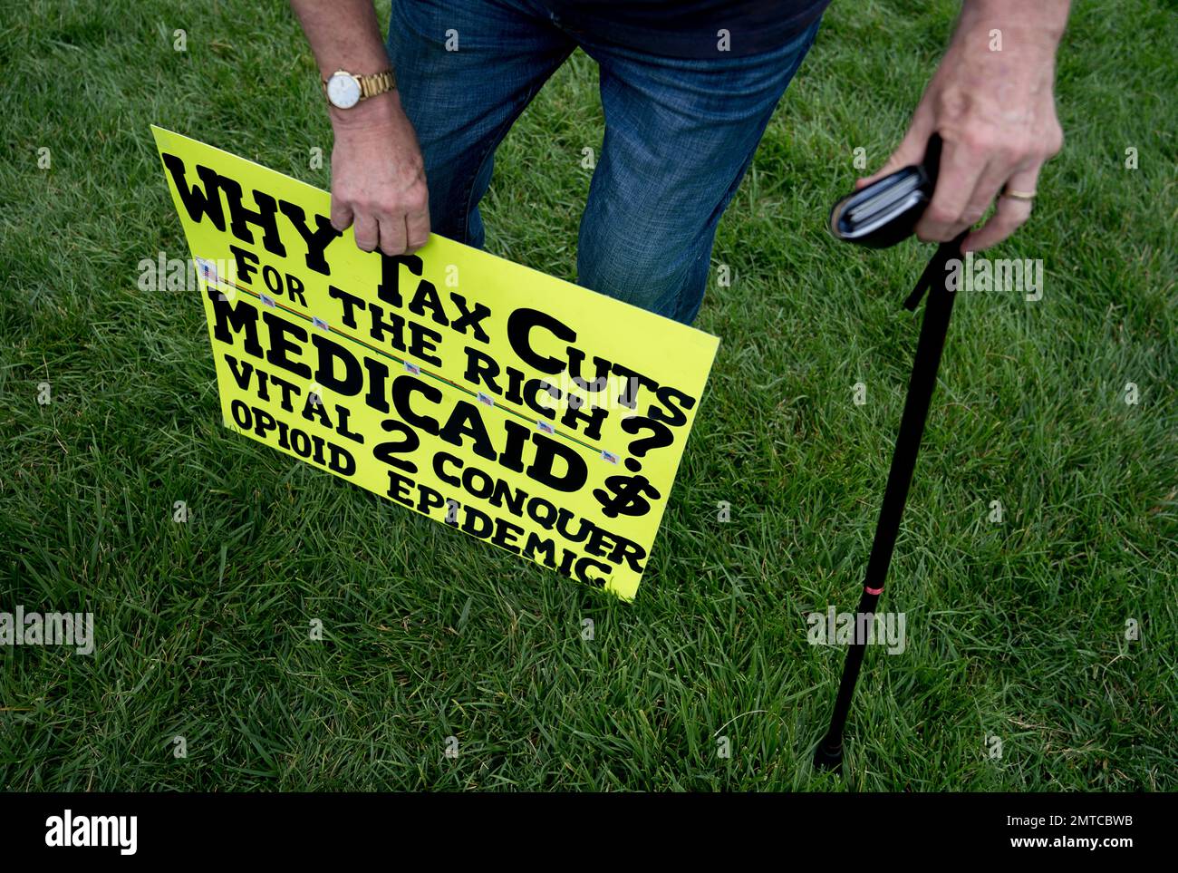 Don Mathis of Bel Air, Md., center, holds a poster as he joins a rally ...