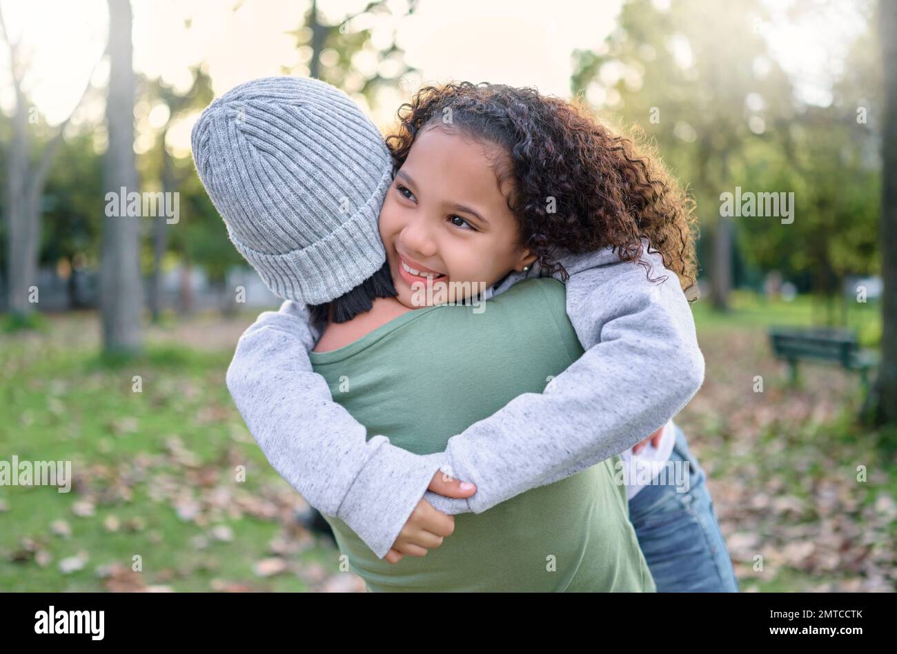 Nature, love and child hugging mother in park with smile on autumn ...
