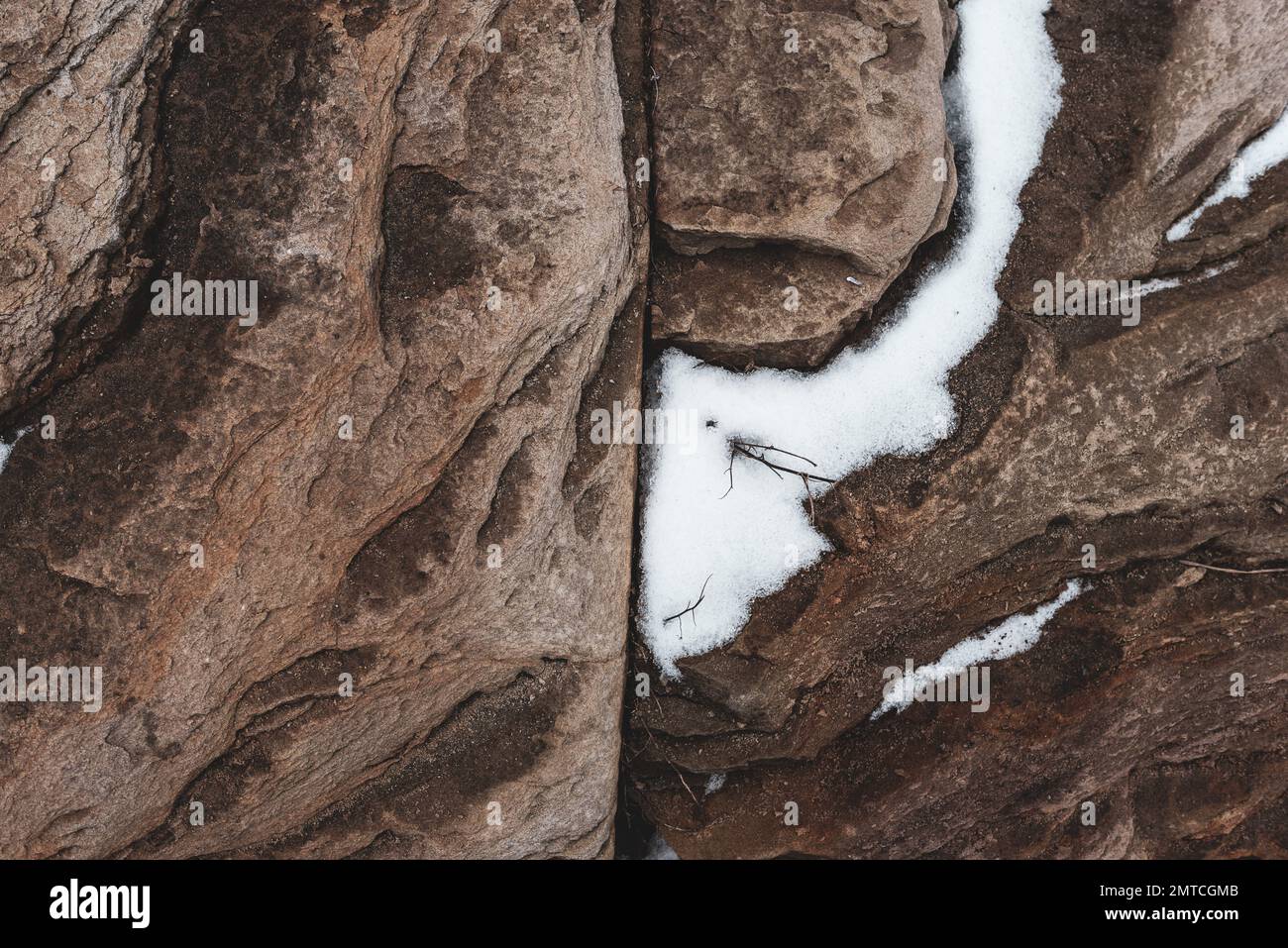 Texture of stone granite rock with snow. The background is natural ...