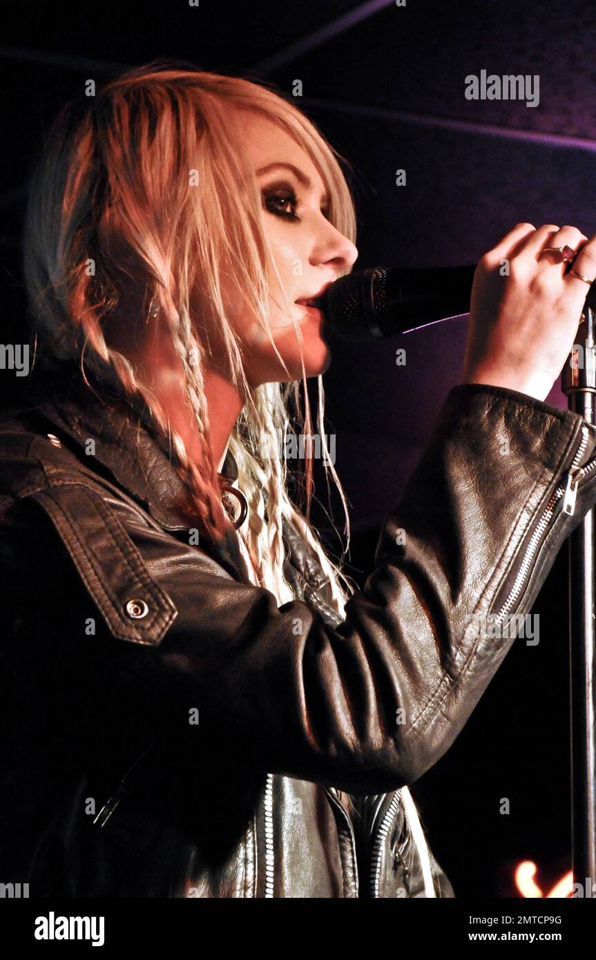 Wearing a black leather jacket and torn t-shirt made into a dress ...