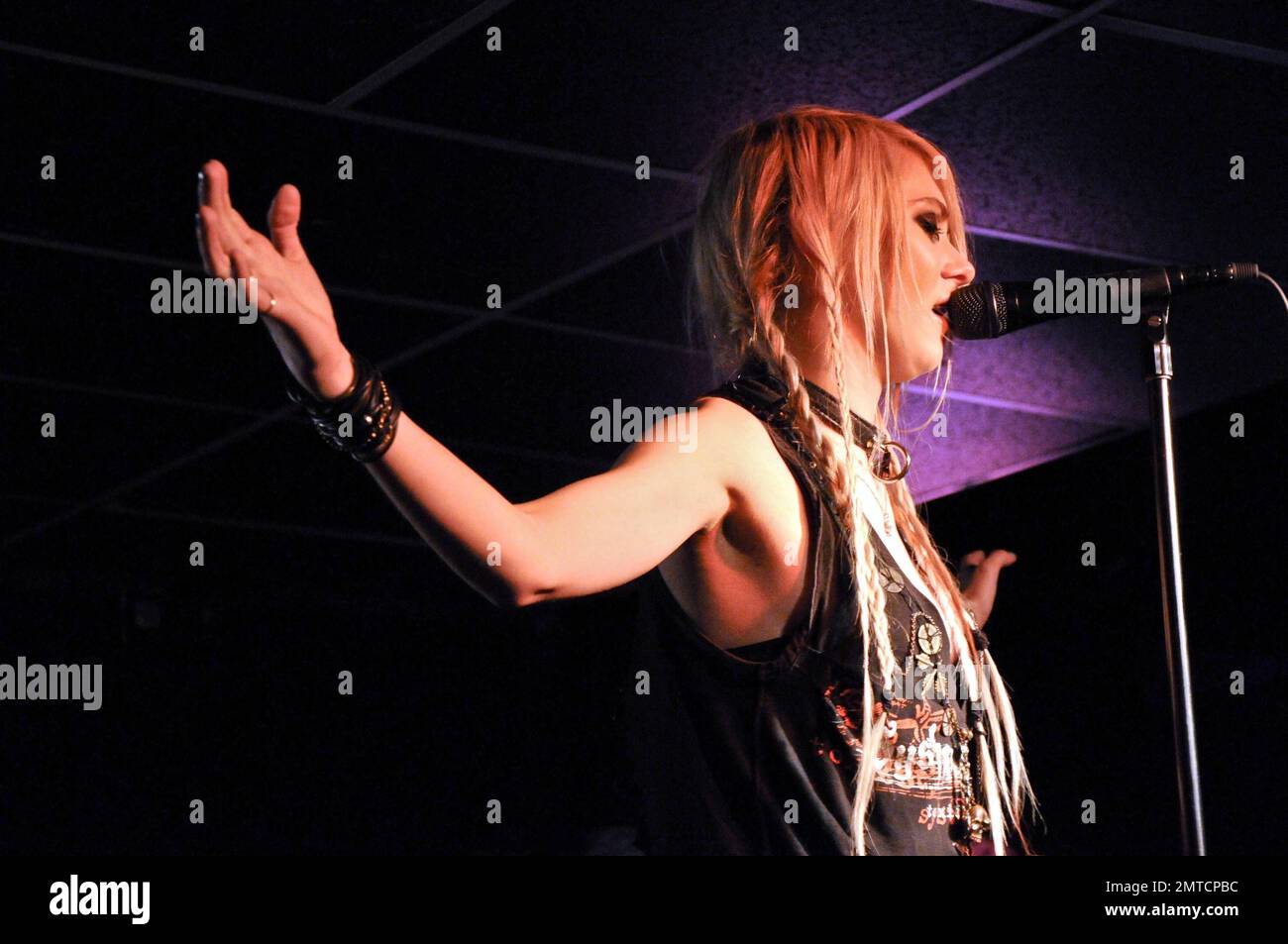 Wearing a black leather jacket and torn t-shirt made into a dress ...