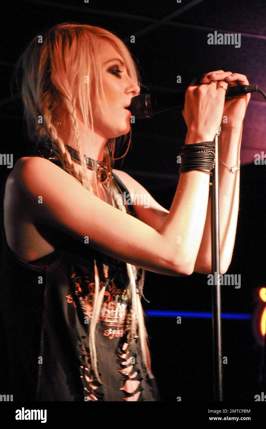 Wearing a black leather jacket and torn t-shirt made into a dress ...