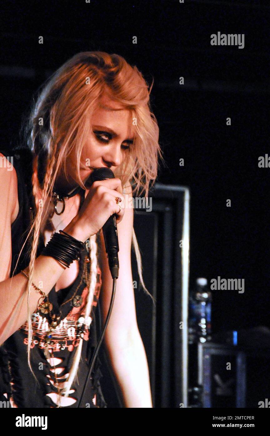 Wearing a black leather jacket and torn t-shirt made into a dress ...