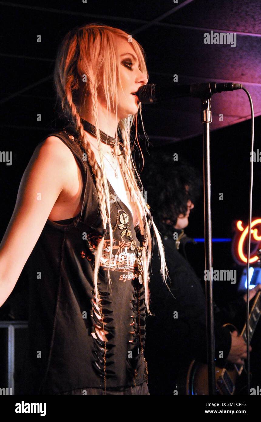 Wearing a black leather jacket and torn t-shirt made into a dress ...