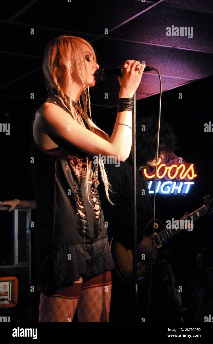 Wearing a black leather jacket and torn t-shirt made into a dress ...