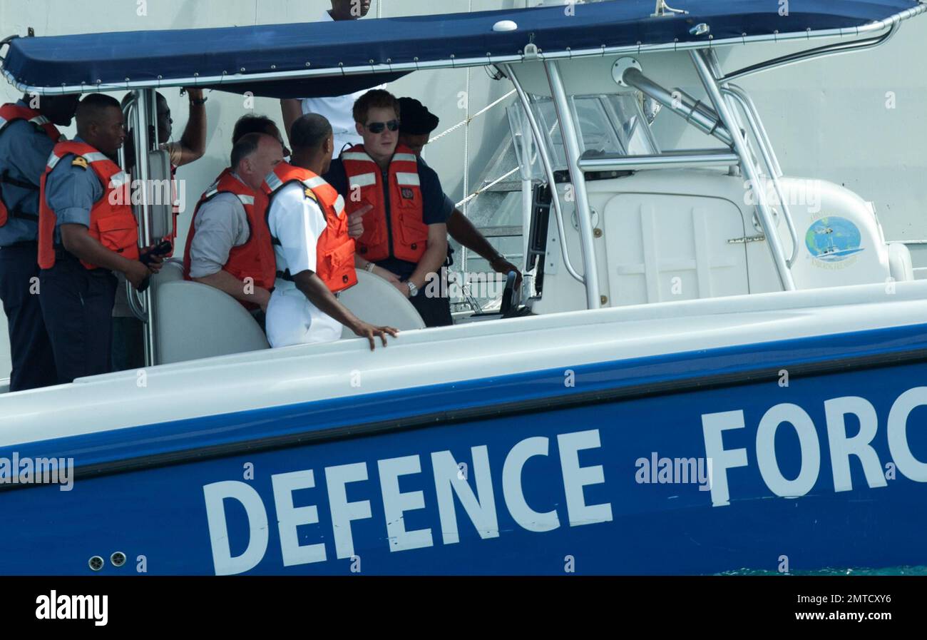 Britain's Prince Harry boards a Royal Bahamas Defence Force speed boat ...
