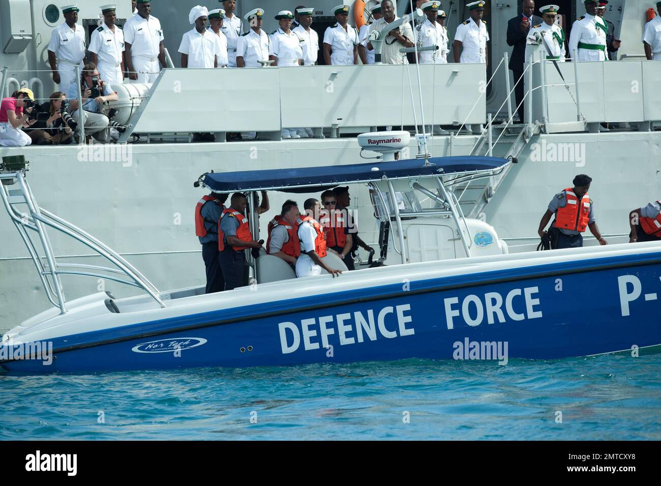 Britain's Prince Harry boards a Royal Bahamas Defence Force speed boat ...