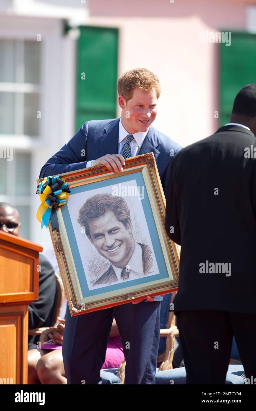 Britain's Prince Harry receives a framed painting of himself by local ...
