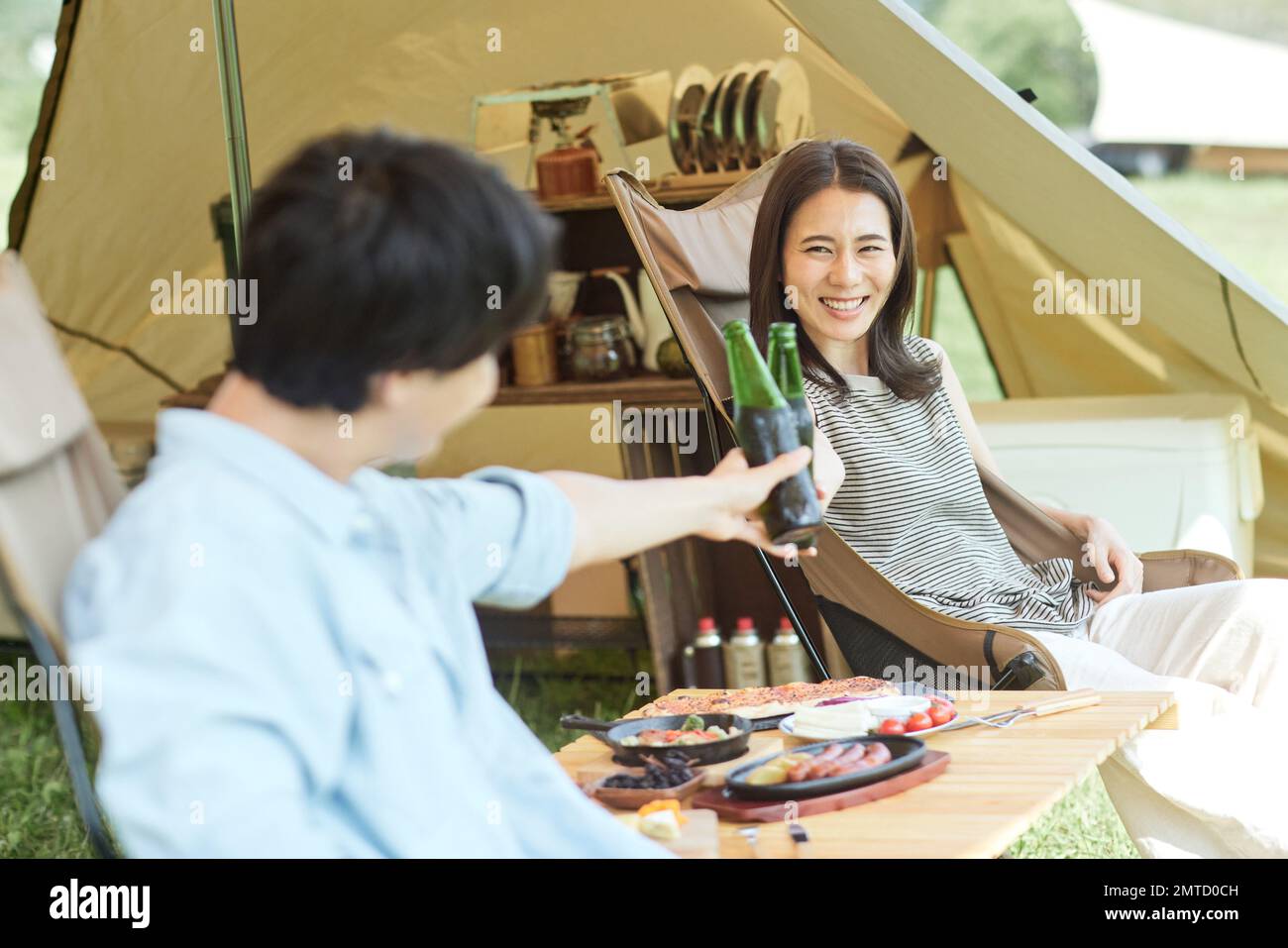 Young Japanese couple at campsite Stock Photo - Alamy