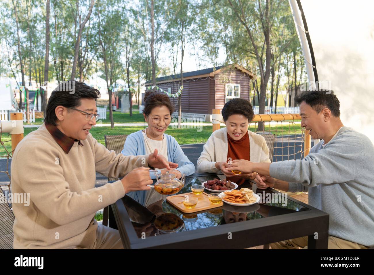 Drinking tea and chatting in old people in the camp Stock Photo - Alamy