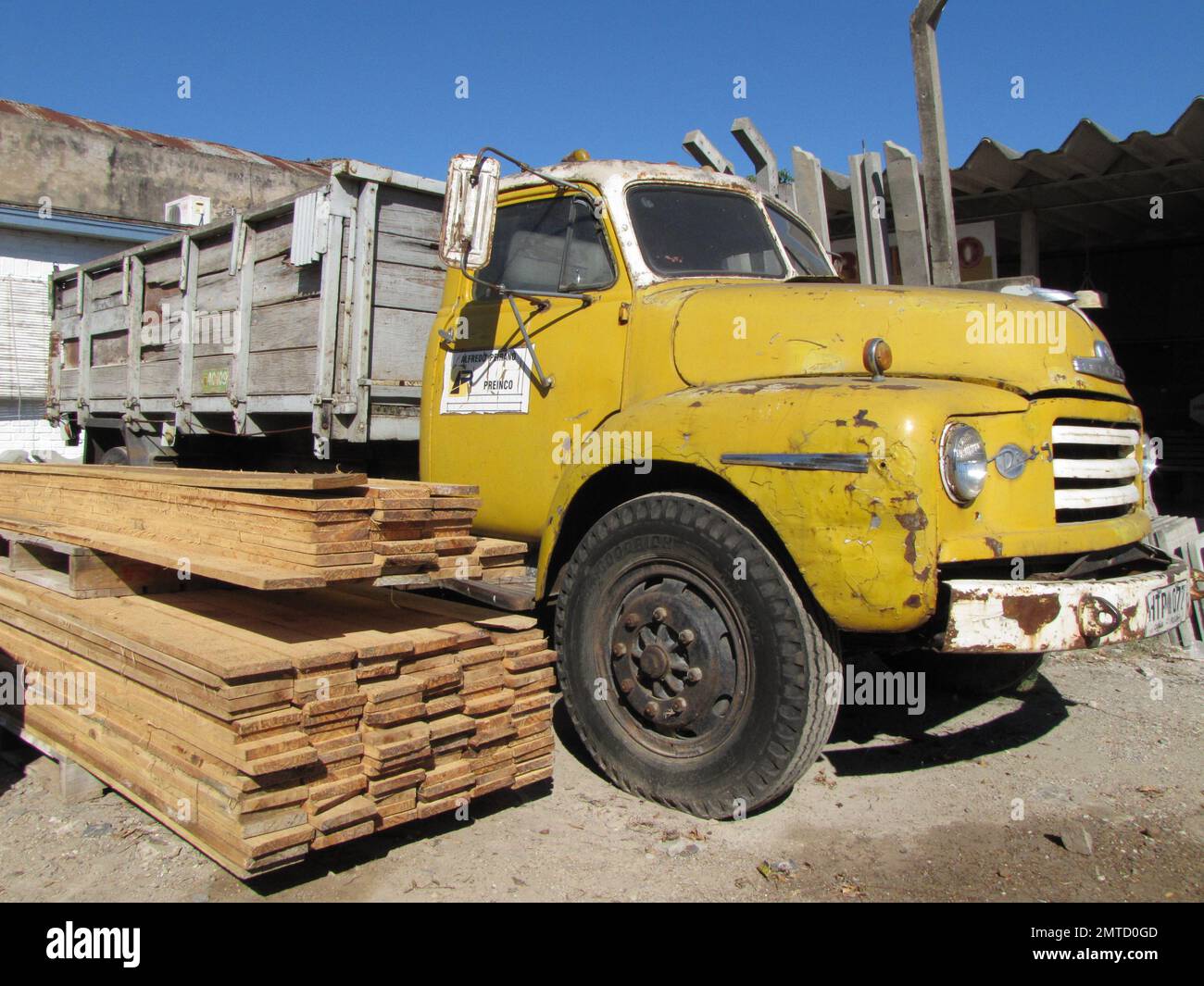 A yellow classic cargo transport vehicle at a construction zone Stock ...