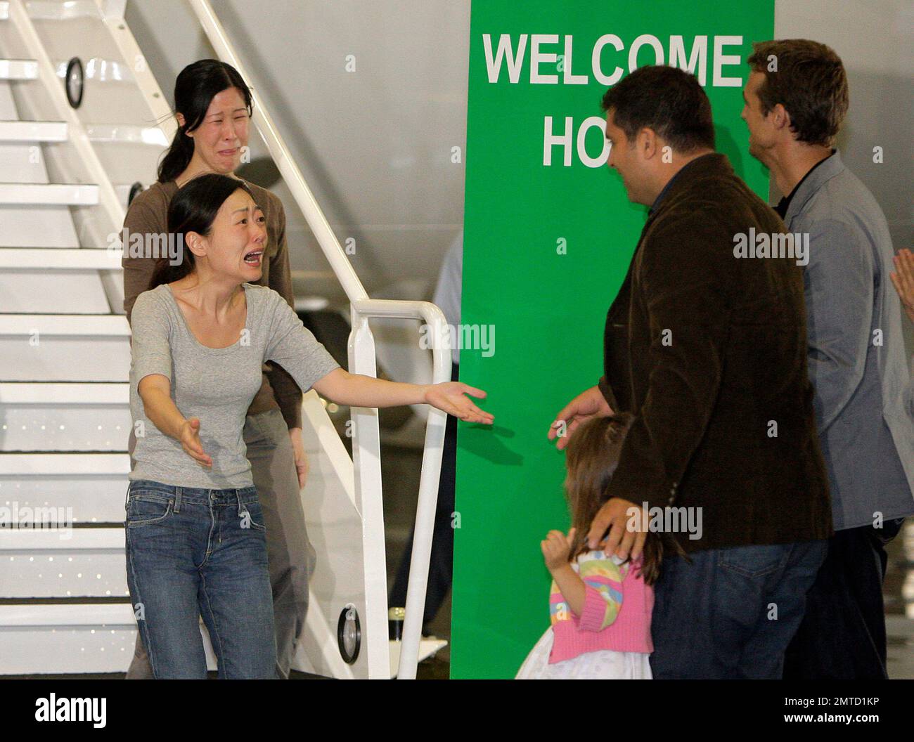 FILE - Euna Lee, left rear, and Laura Ling, left, two American ...
