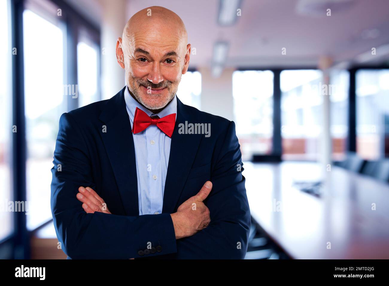 Executive businessman wearing suit and bow tie while standing at the ...