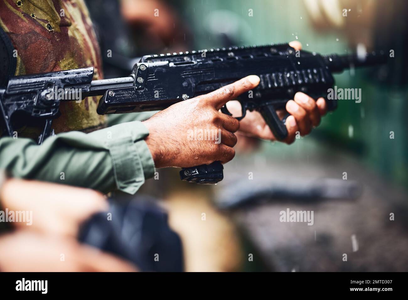 War, battle and hands with a paintball gun for a game, competition or ...