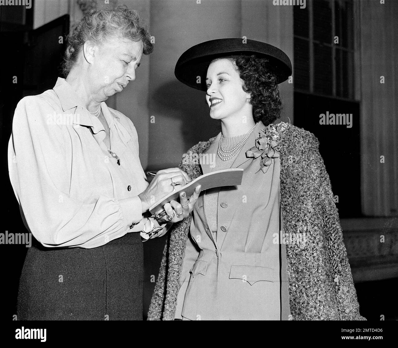 First lady Eleanor Roosevelt, left, buys a $100 war bond from Miss ...