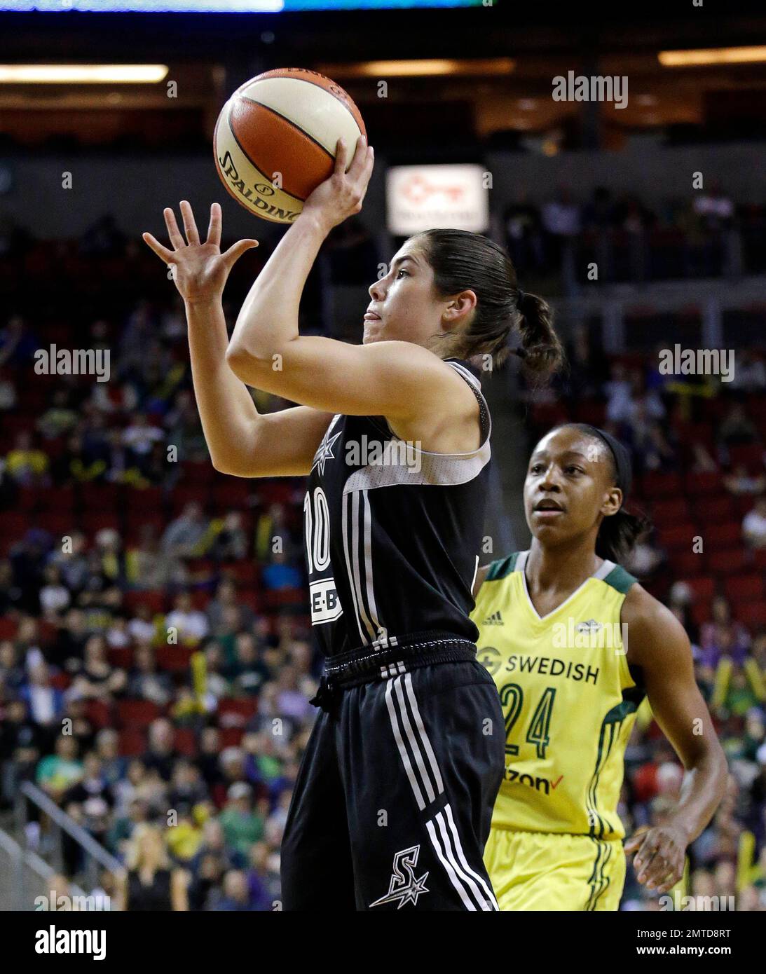 San Antonio Stars' Kelsey Plum, left, shoots in front of Seattle Storm ...