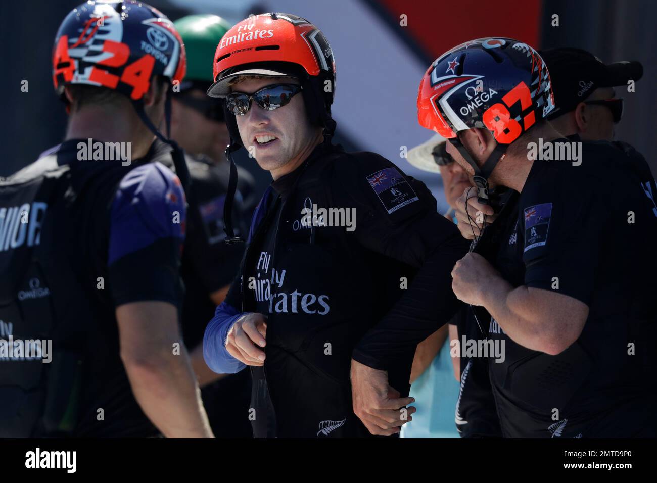 Emirates Team New Zealand Helmsman Peter Burling, center, takes off ...