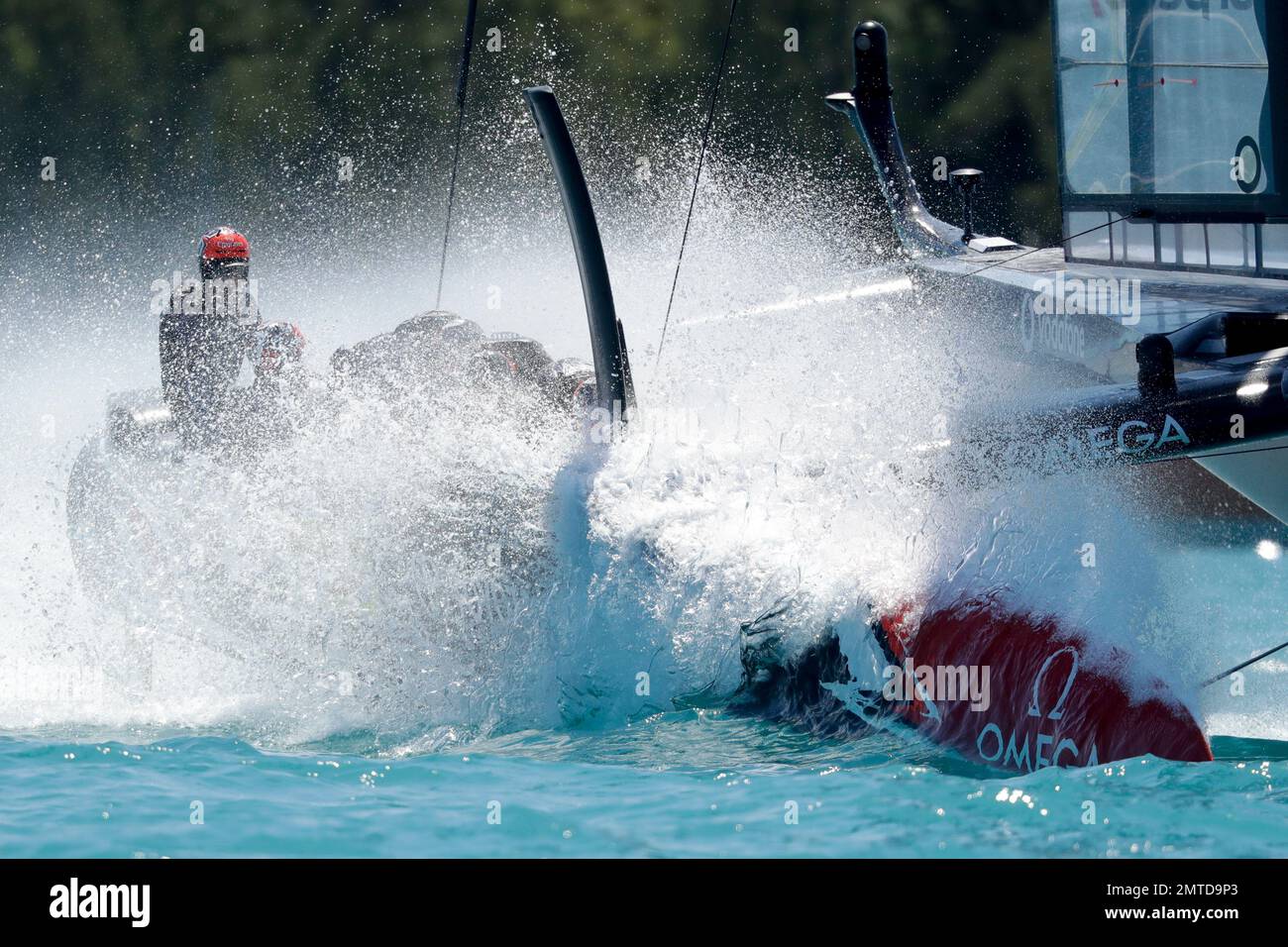 Emirates Team New Zealand Helmsman Peter Burling, left, dips a bow into ...