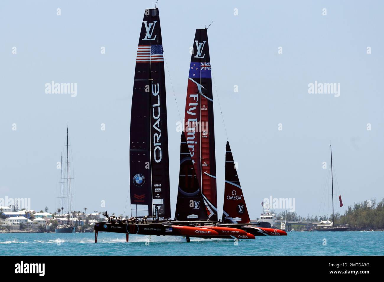 Oracle Team USA, left, races Emirates Team New Zealand during the third ...