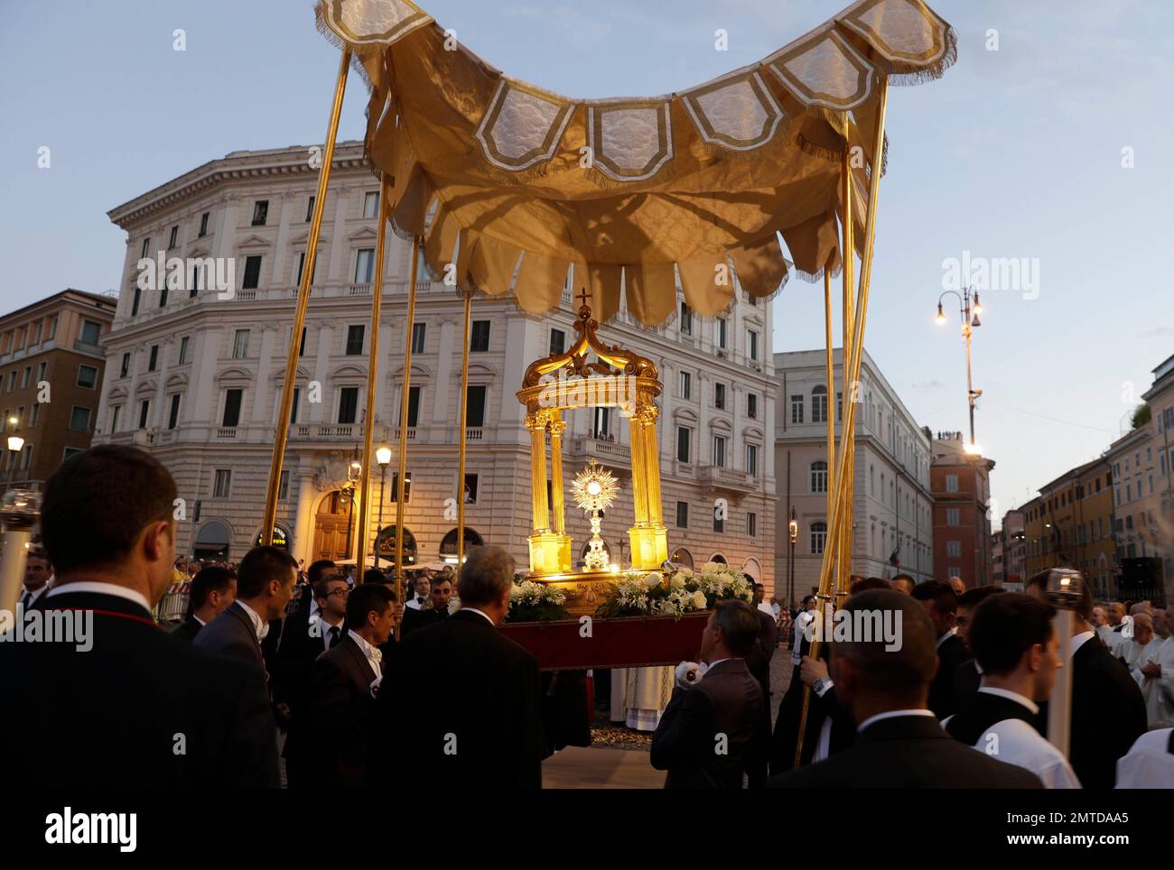 Faithful carry a monstrance containing a Holy Host Corpus Domini ...