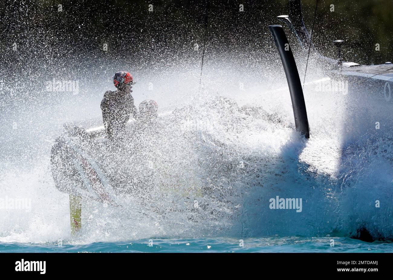 Emirates Team New Zealand Helmsman Peter Burling, left, dips a bow into ...