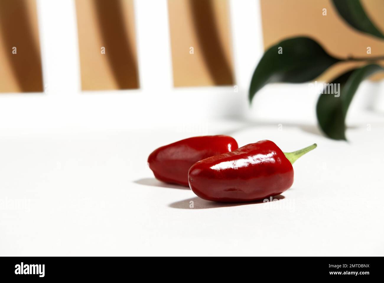 Red mini chili pepper isolated on white and beige background with hard ...