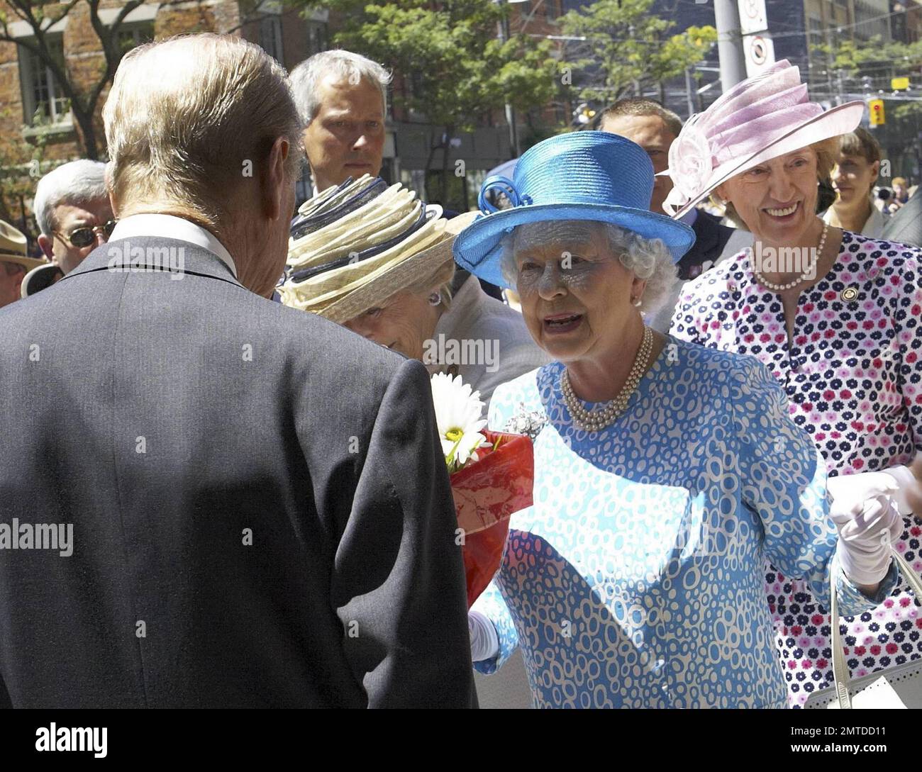 Queen Elizabeth II of England and Prince Philip leave St. James' Cathedral in Toronto after ...