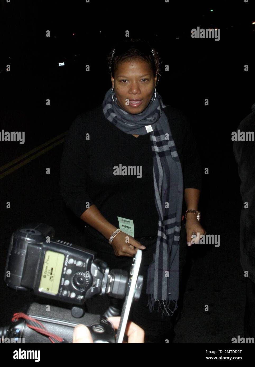 Singer, rapper and actress Queen Latifah flashes a peace sign and talks ...