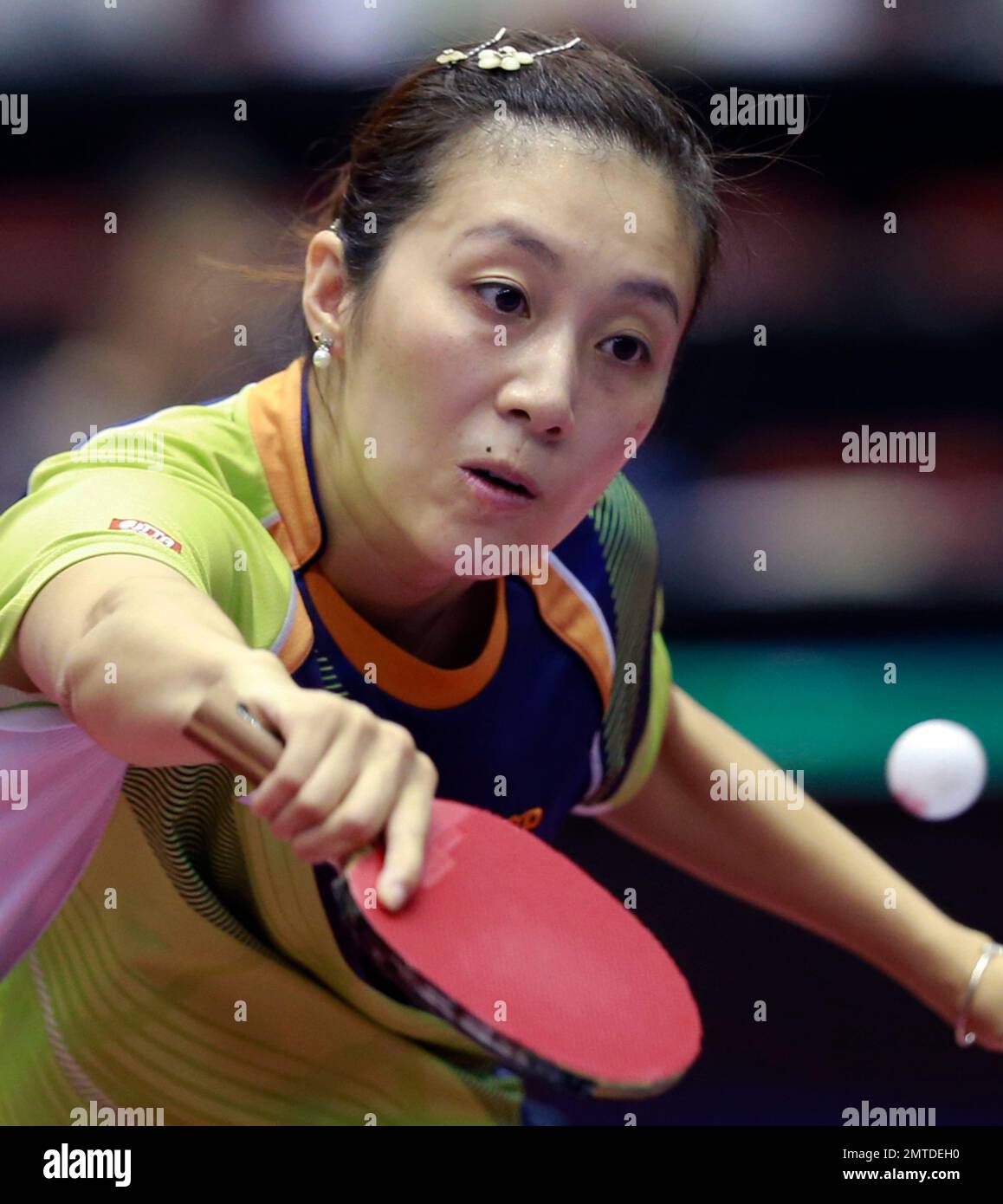 Han Ying of Germany returns a shot against Chen Meng of China during ...