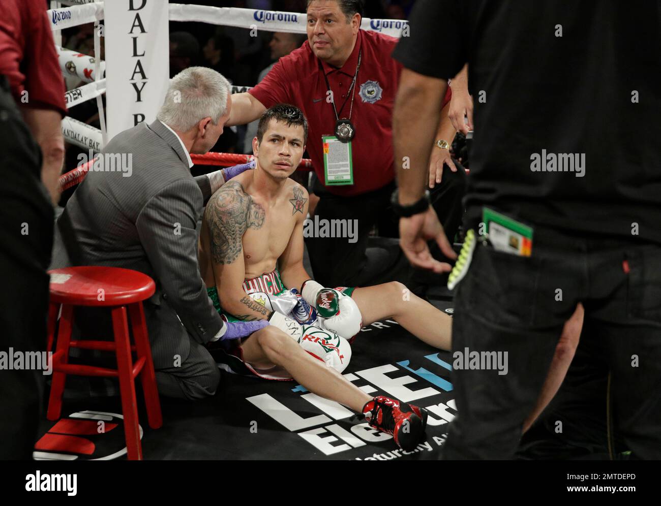 Moises Flores sits on the mat after he was knocked down by Guillermo ...