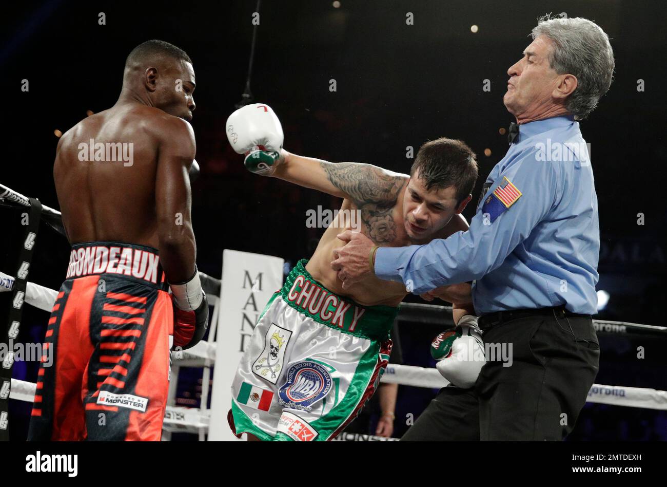 Moises Flores falls into referee Vic Drakulich as Flores was knocked ...